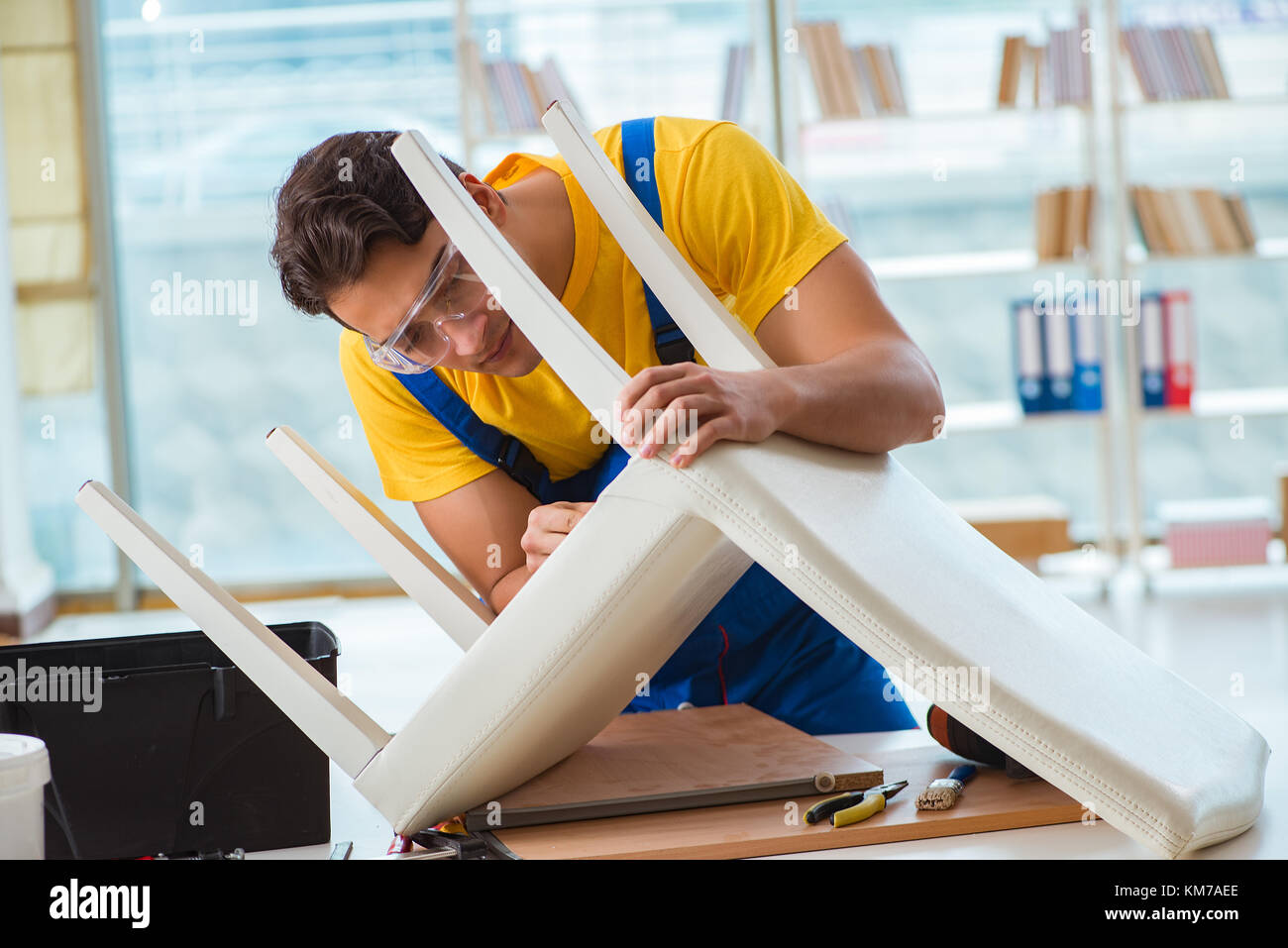 Furniture repairman working on repairing the chair Stock Photo - Alamy