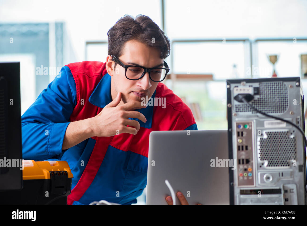 Computer repairman working on repairing computer in IT workshop Stock ...