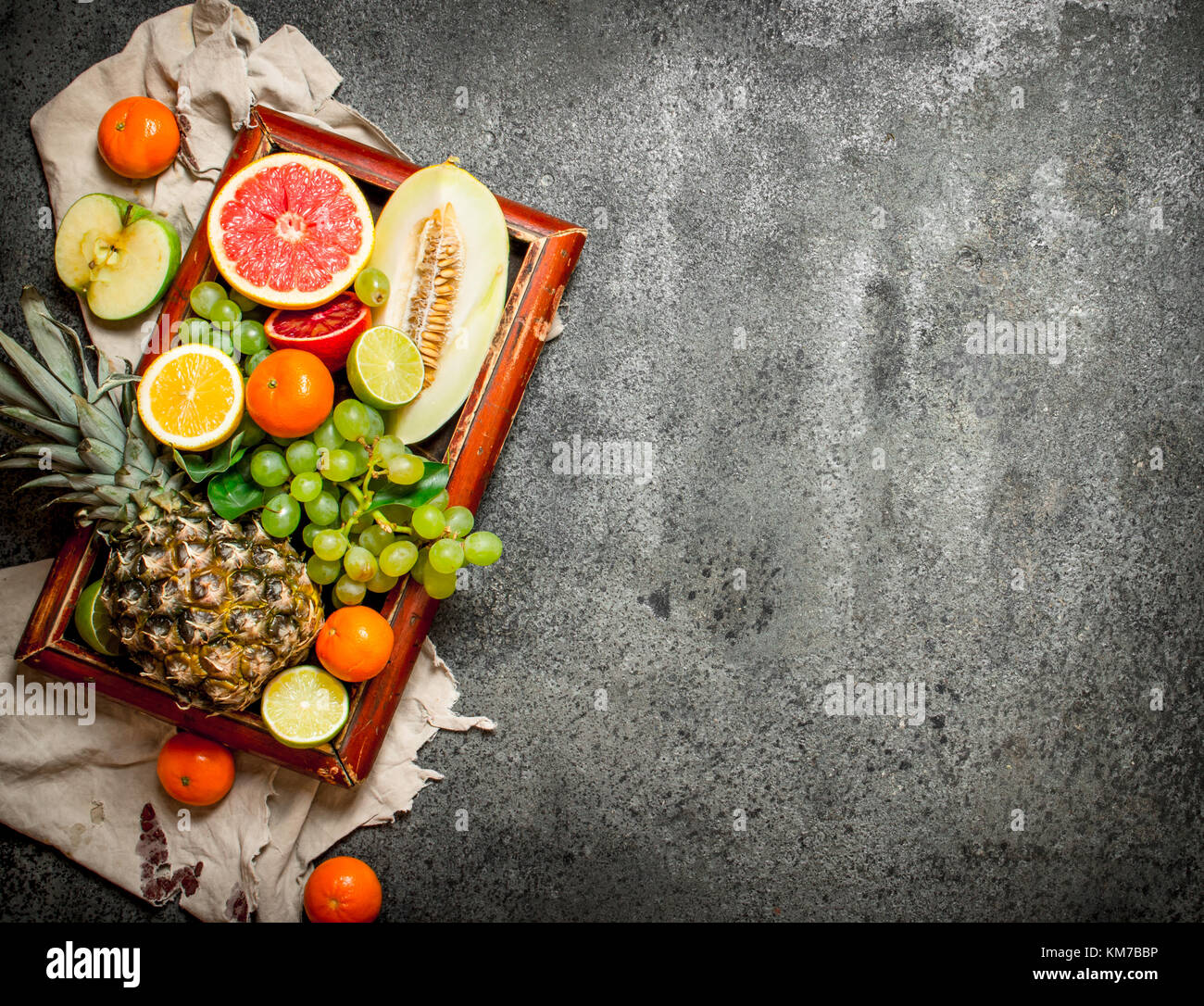 Ripe fruits in the old tray. On rustic background Stock Photo - Alamy