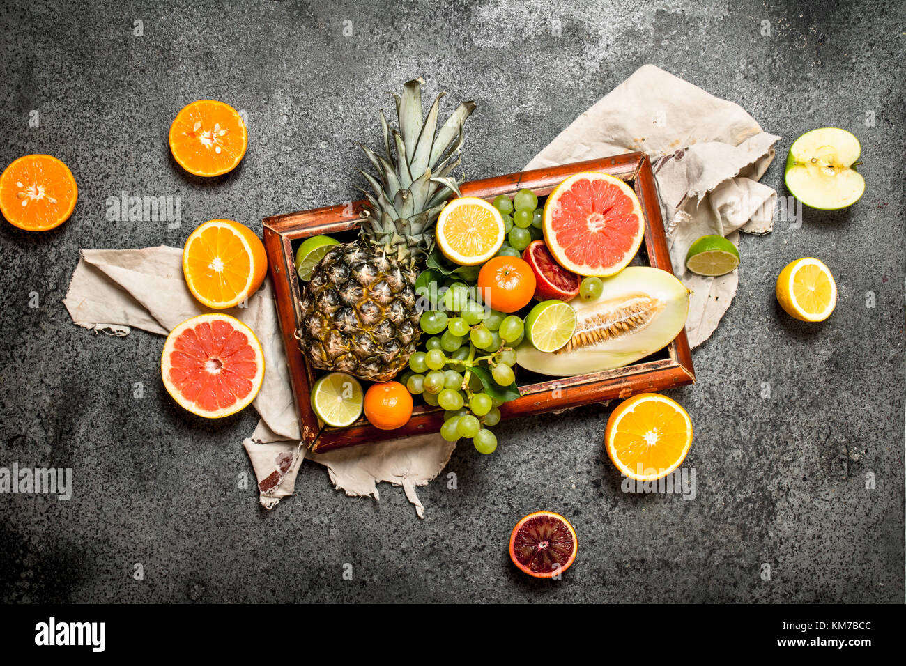 Ripe fruits in the old tray. On rustic background Stock Photo - Alamy