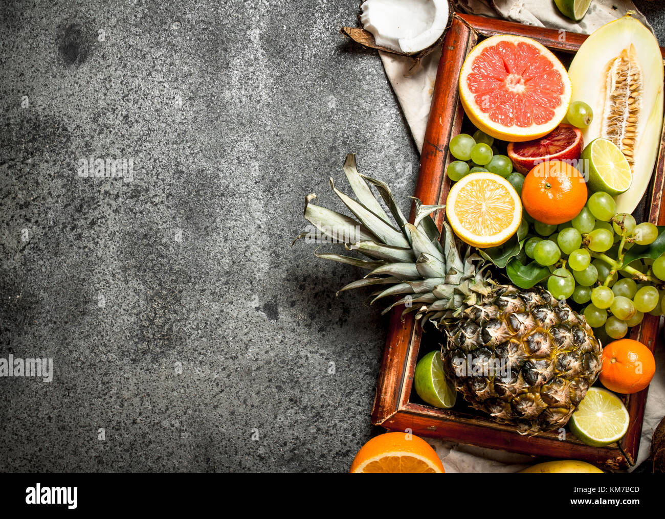 Ripe fruits in the old tray. On rustic background Stock Photo - Alamy