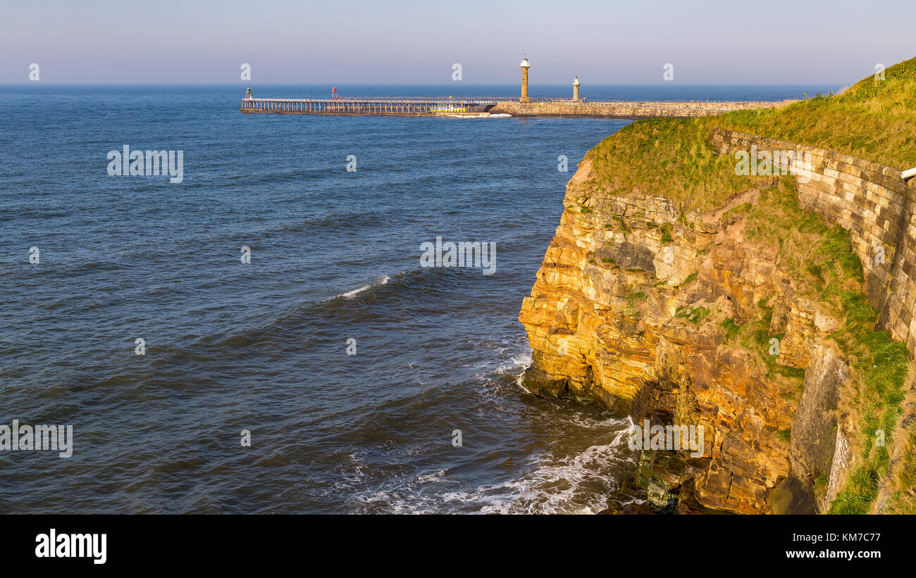 Whitby West cliff and pier, North Yorkshire, UK Stock Photo - Alamy