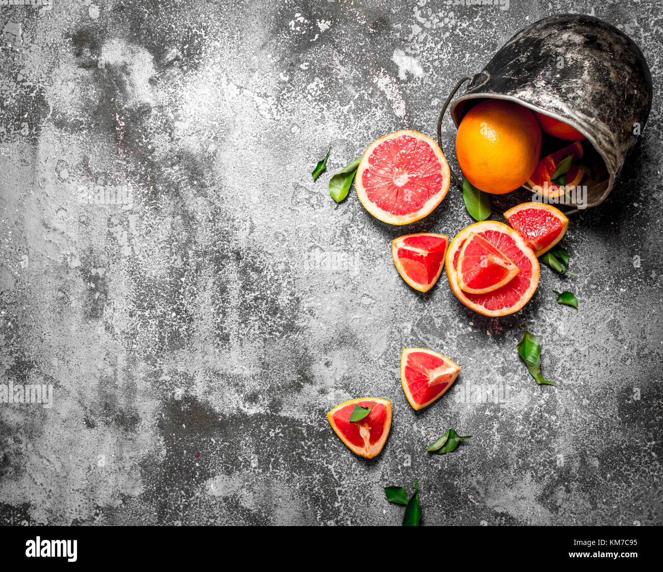 Ripe grapefruits in the old bucket. On rustic background Stock Photo ...