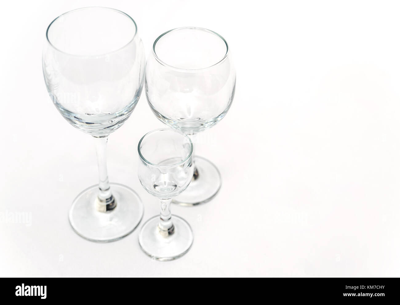 Three glasses of different sizes on a white background Stock Photo - Alamy