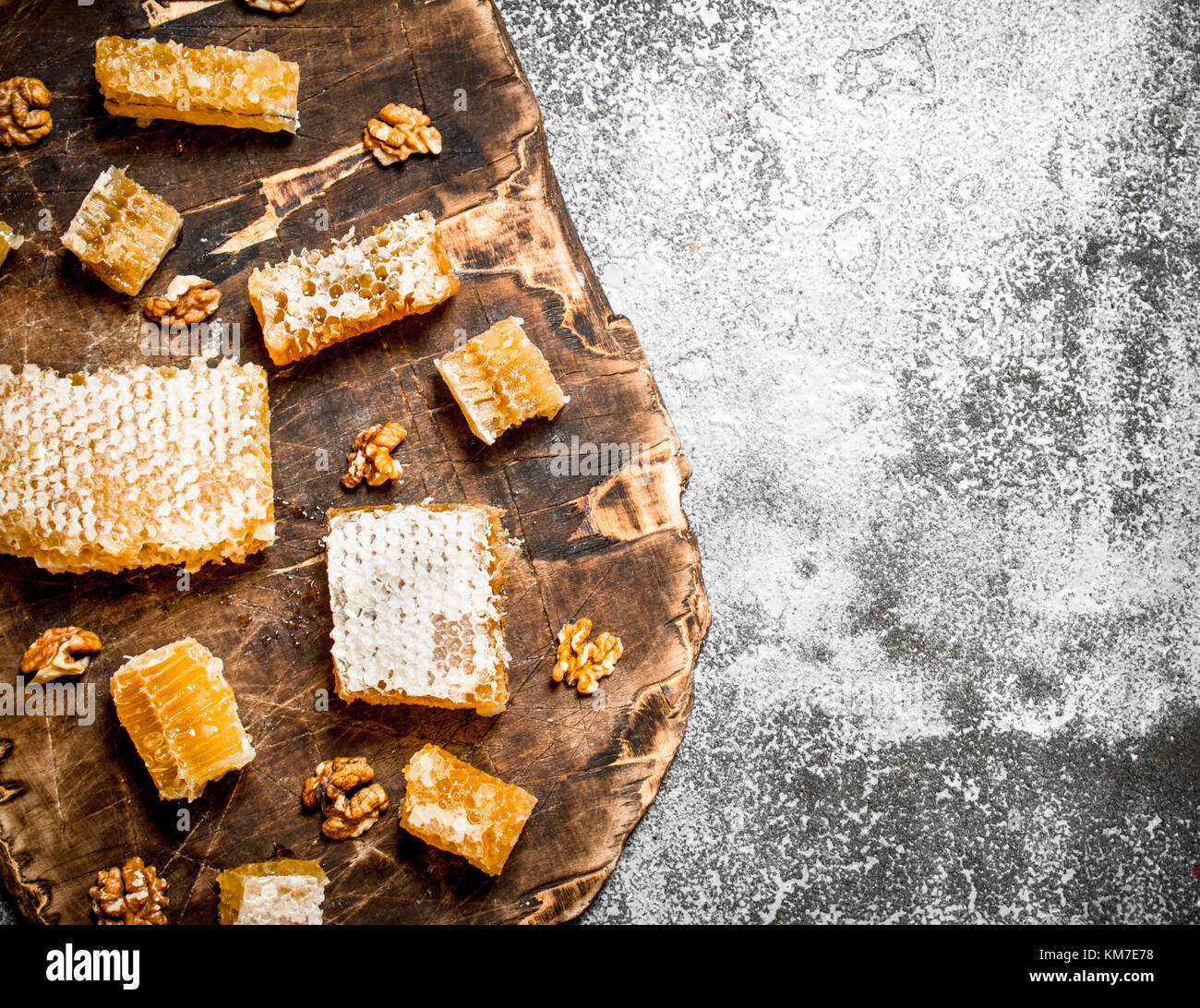 Fresh honeycomb with nuts. On rustic background Stock Photo - Alamy