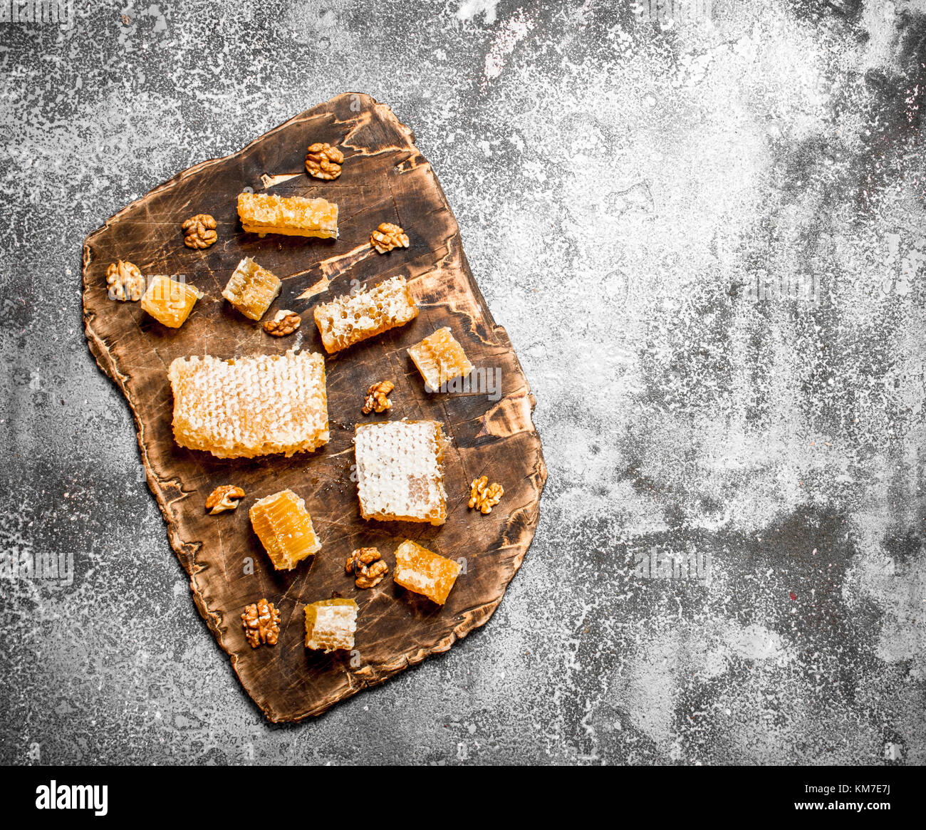 Fresh honeycomb with nuts. On rustic background Stock Photo - Alamy