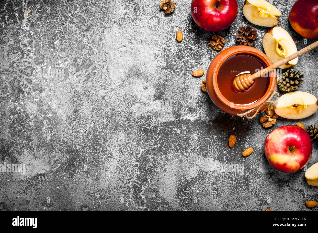 Honey background. Honey in pot with apples and nuts. On rustic ...