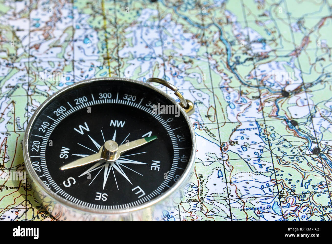 Travel and adventure! The magnetic compass lies on a topographic map ...