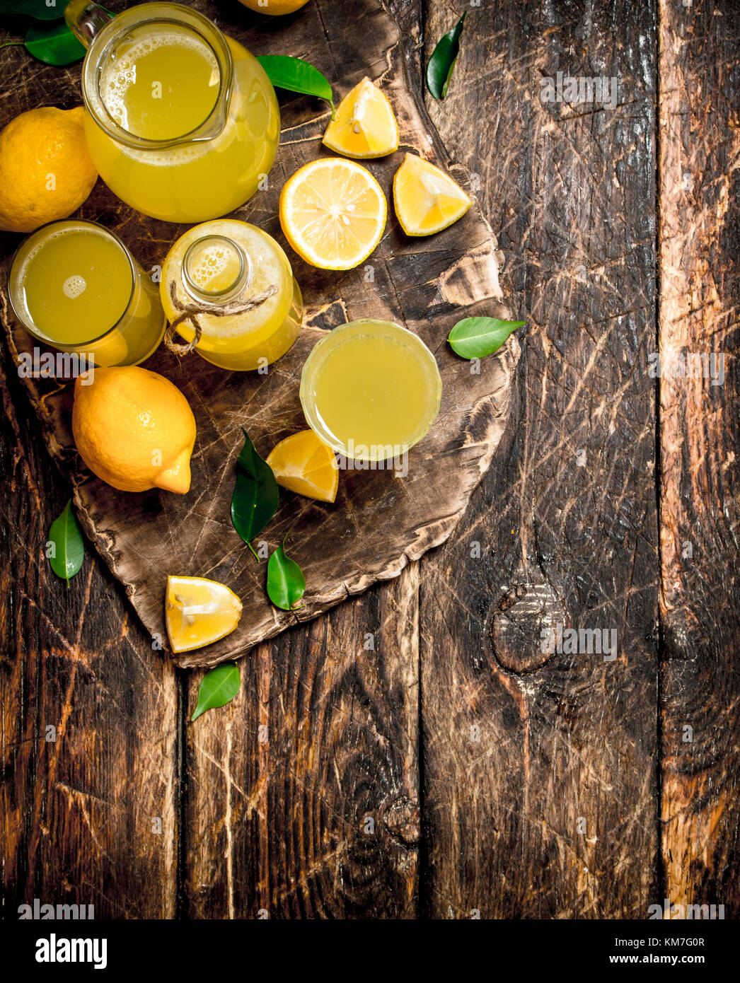Fresh lemonade made with ripe lemons. On wooden background Stock Photo ...