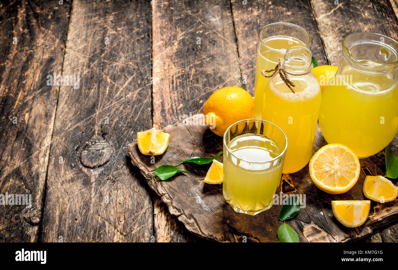 Fresh lemonade made with ripe lemons. On wooden background Stock Photo ...