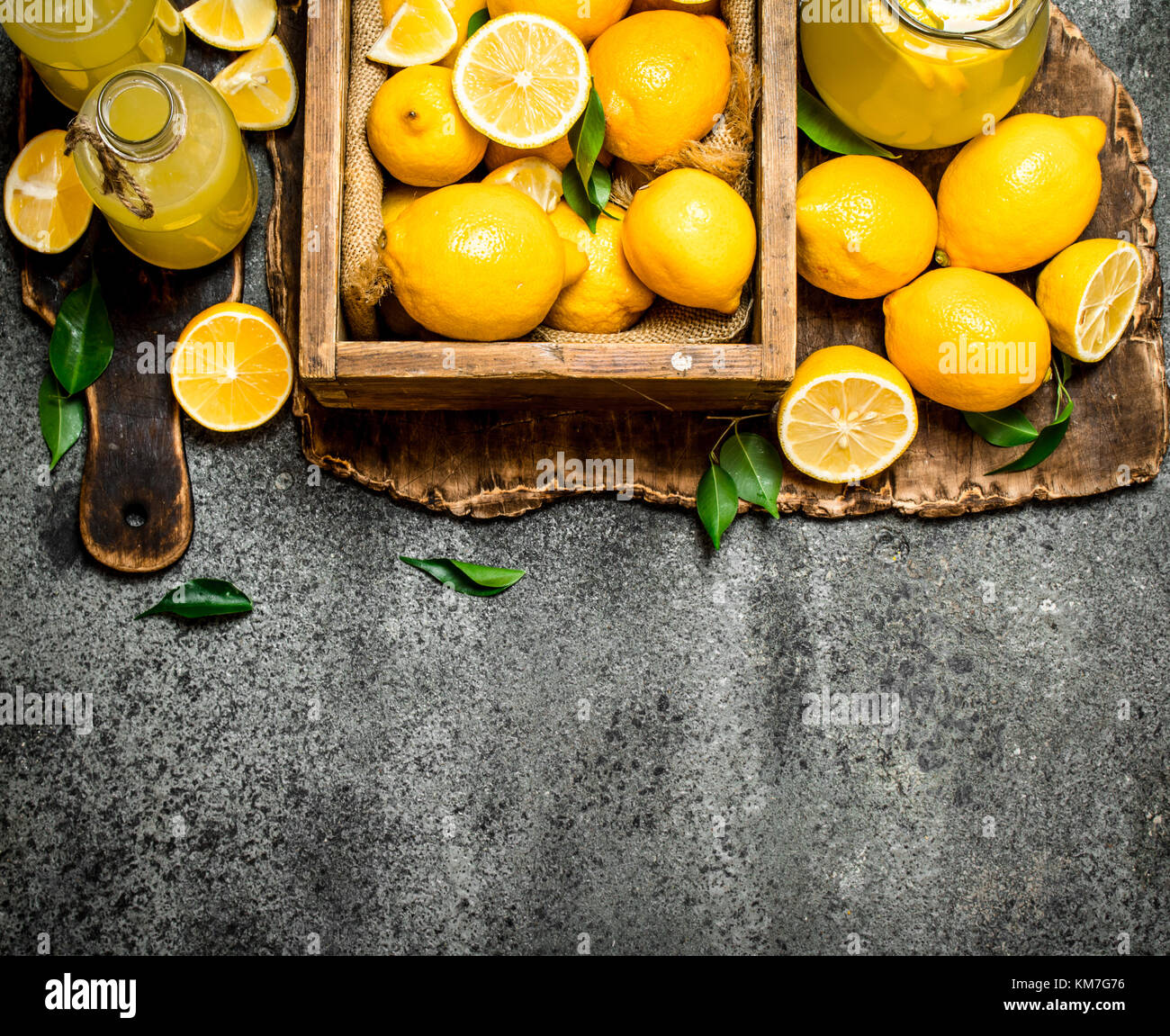 Fresh lemonade from ripe lemons in the box. On rustic background Stock ...