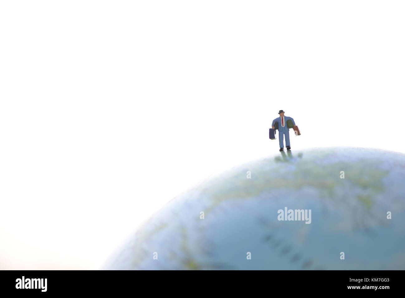 Traveller tourist globetrotter with bags standing on a map of the world ...