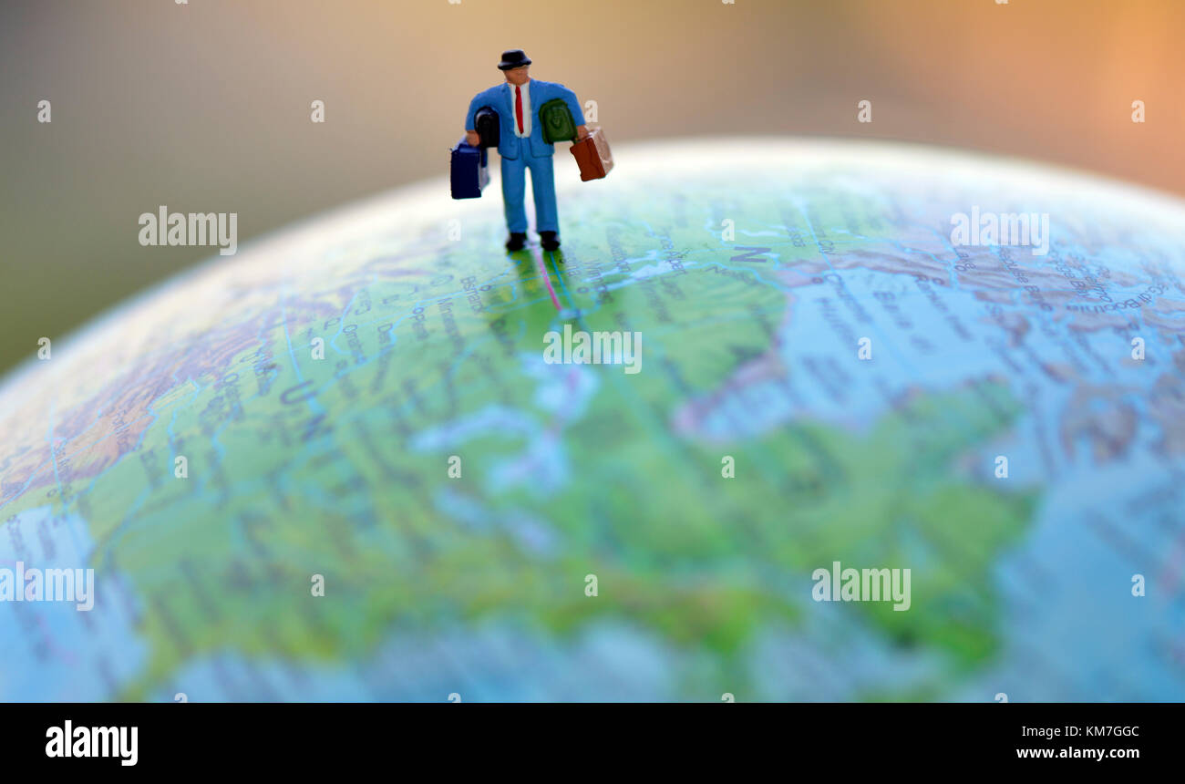 Traveller tourist globetrotter with bags standing on a map of the world ...
