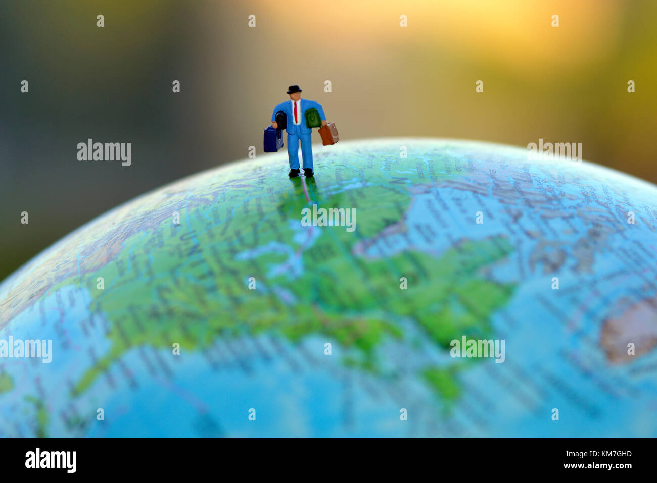 Traveller tourist globetrotter with bags standing on a map of the world ...