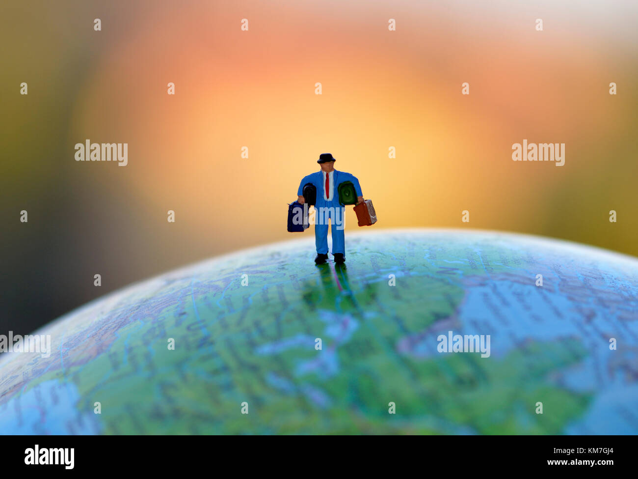 Traveller tourist globetrotter with bags standing on a map of the world ...
