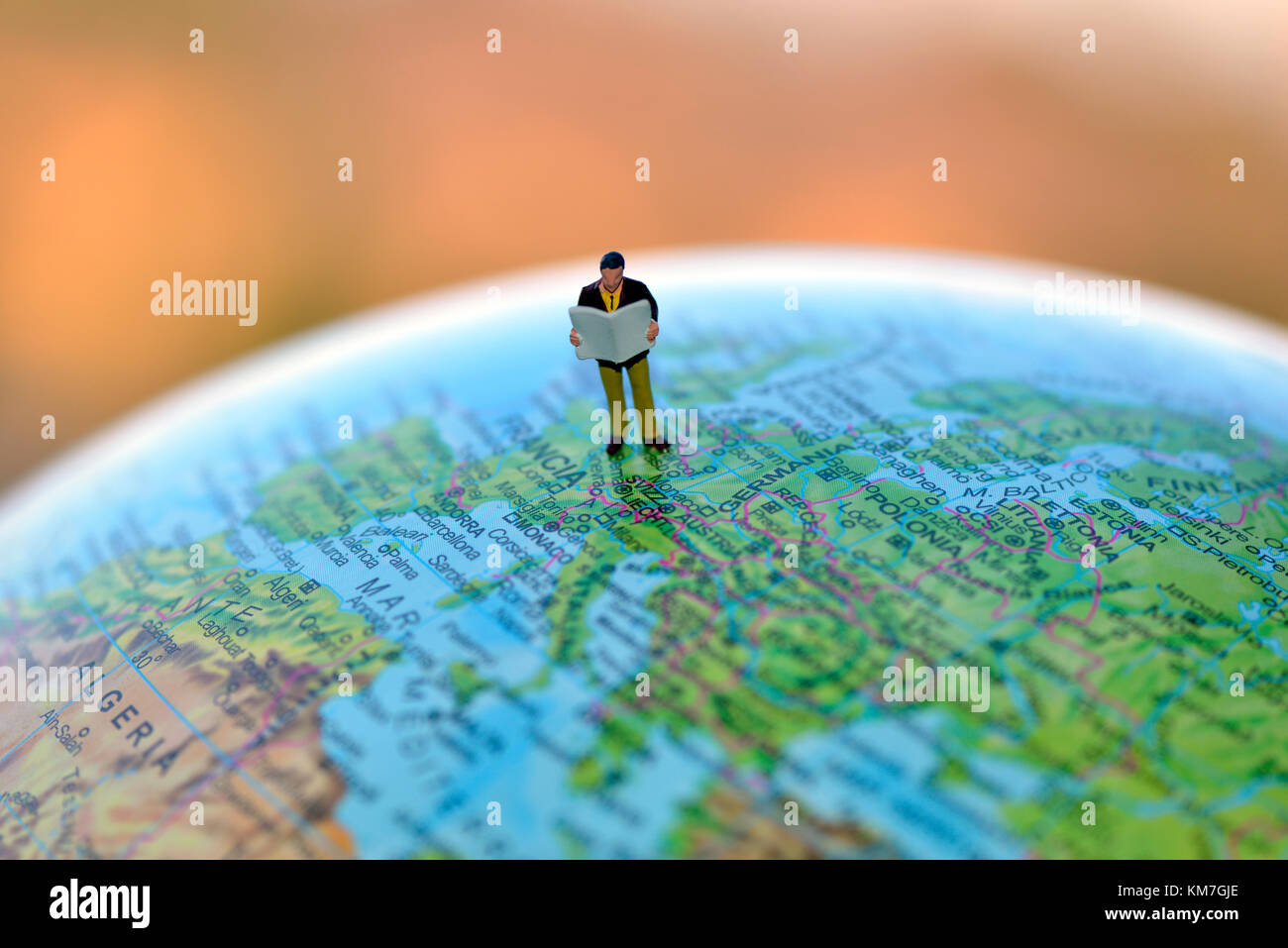 Traveller tourist globetrotter with bags standing on a map of the world ...