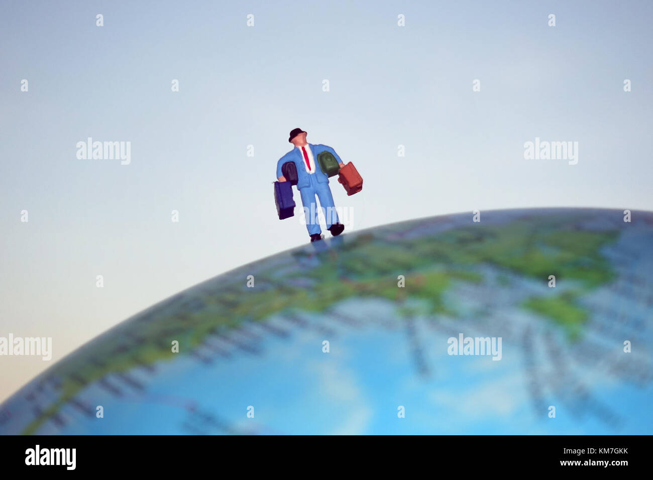 Traveller tourist globetrotter with bags standing on a map of the world ...