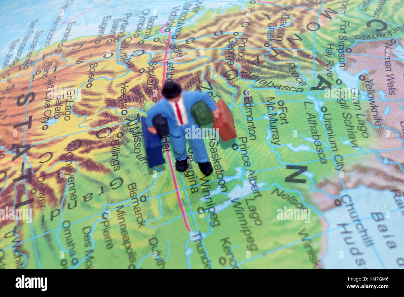 Traveller tourist globetrotter with bags standing on a map of the world ...