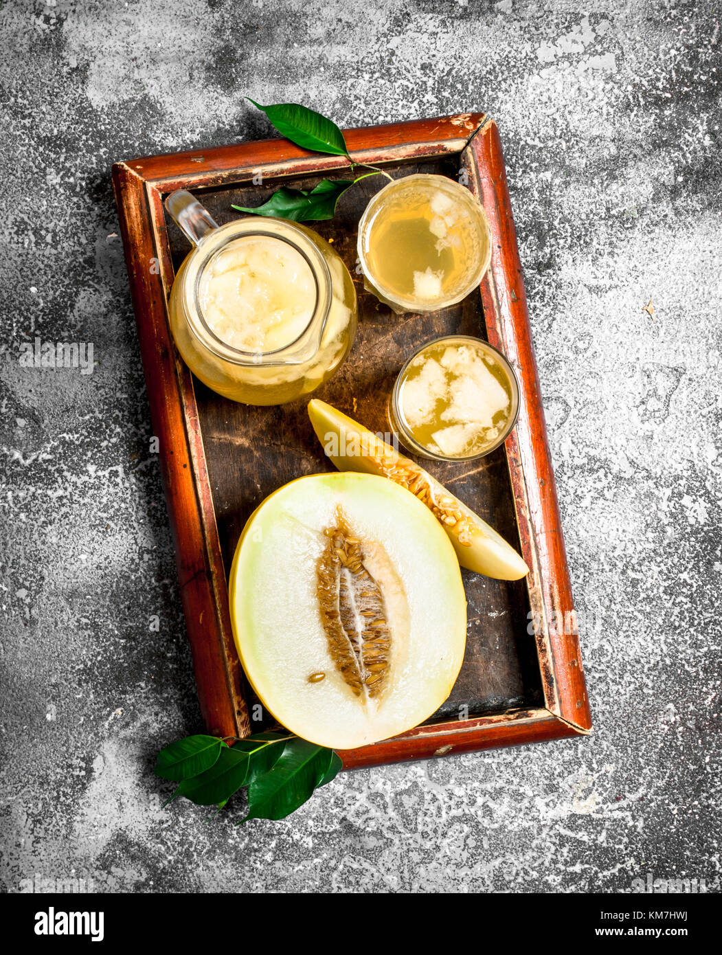 The fresh juice of ripe melon. On rustic background Stock Photo - Alamy
