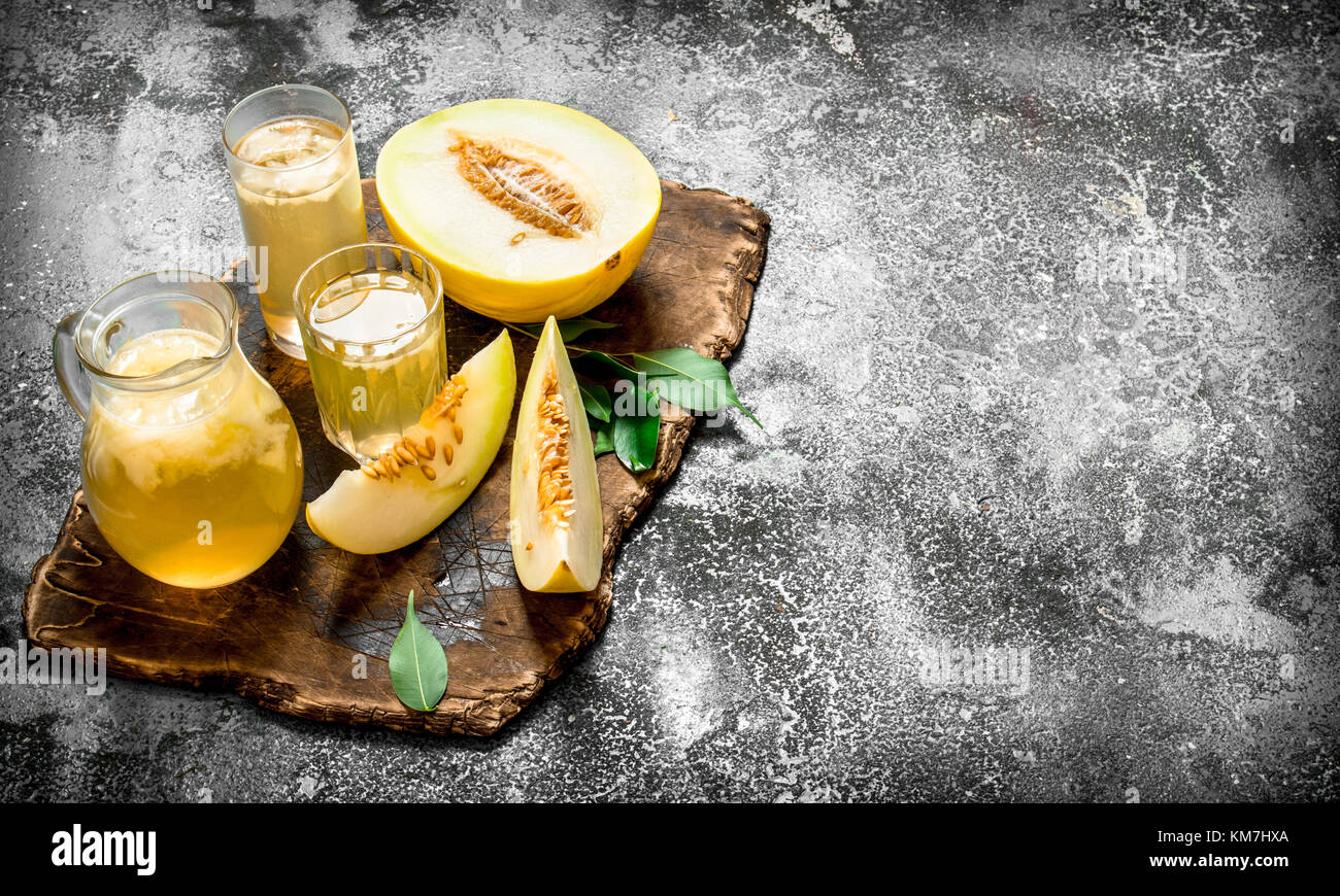 The fresh juice of ripe melon. On rustic background Stock Photo - Alamy