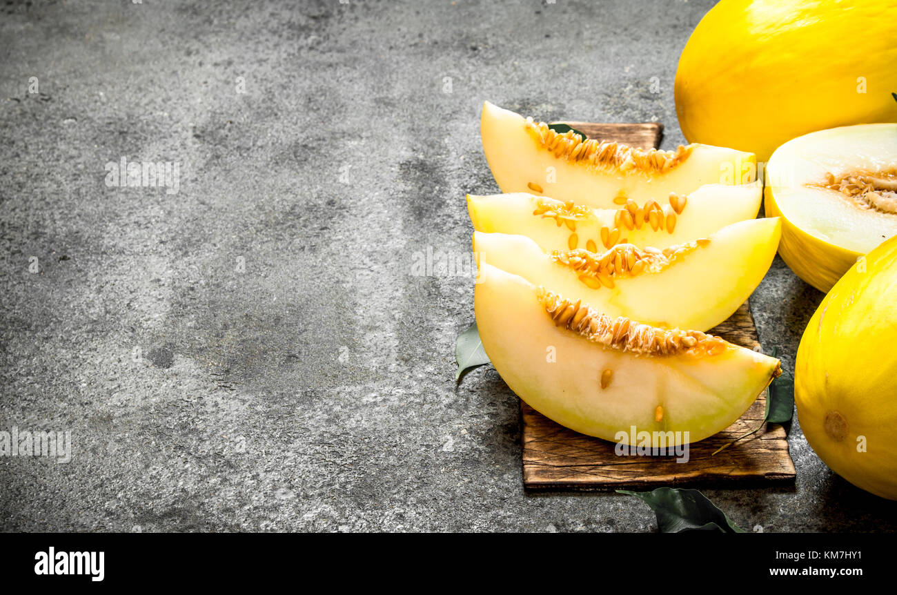 Ripe reipe melon . On a rustic background Stock Photo - Alamy