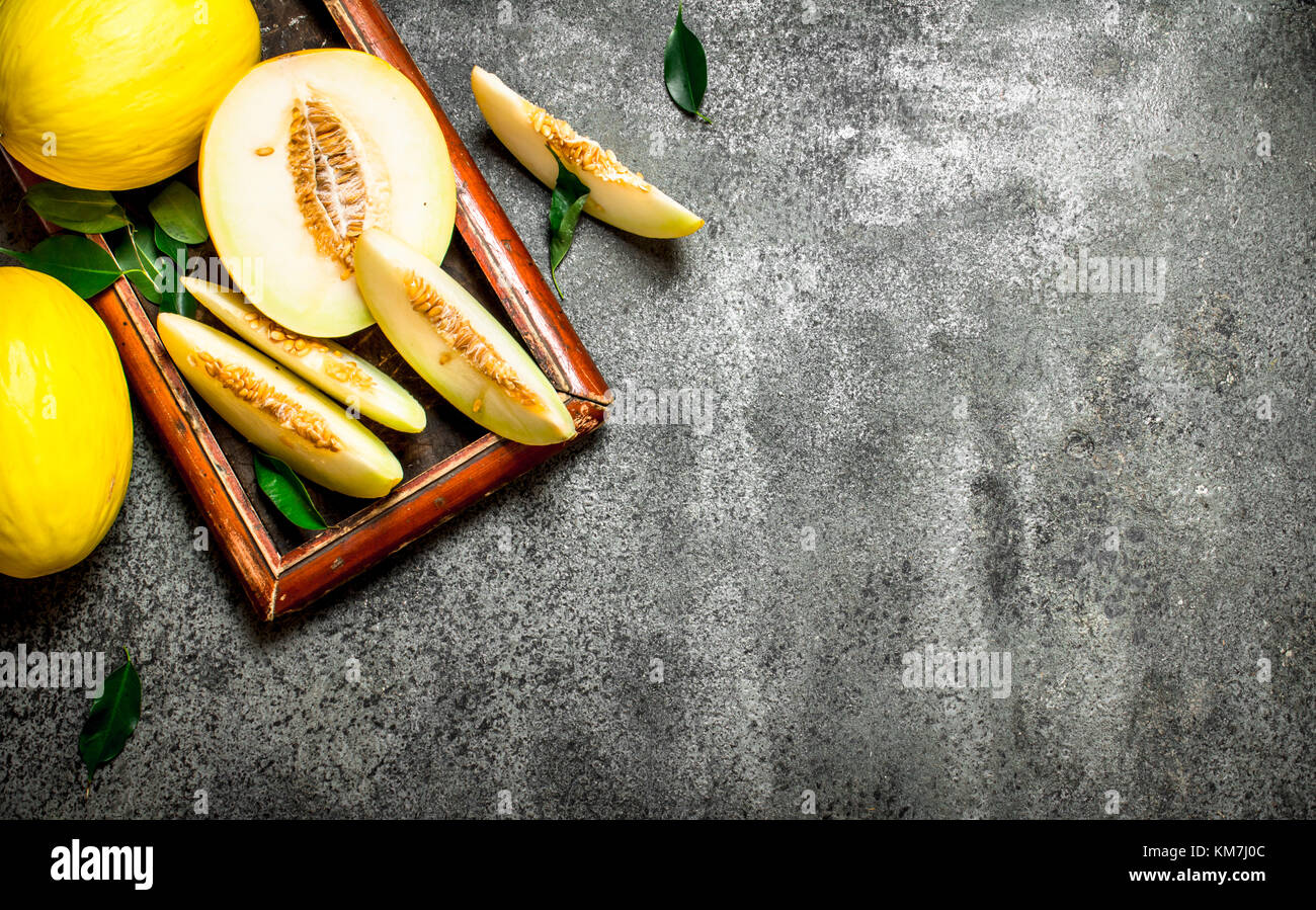 Ripe fresh melon . On the rustic background Stock Photo - Alamy