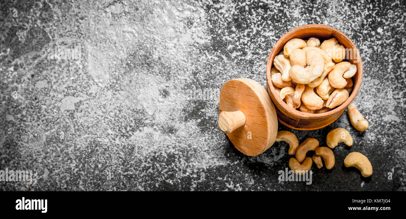 Cashew in wooden container. On rustic background Stock Photo - Alamy