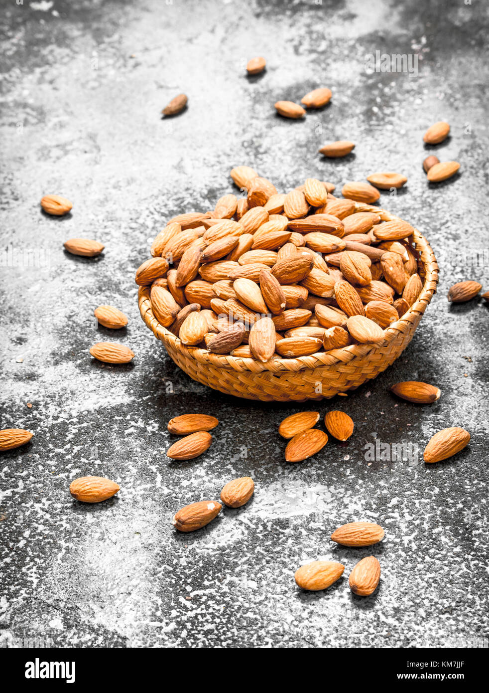 Almonds in the basket. On rustic background Stock Photo - Alamy