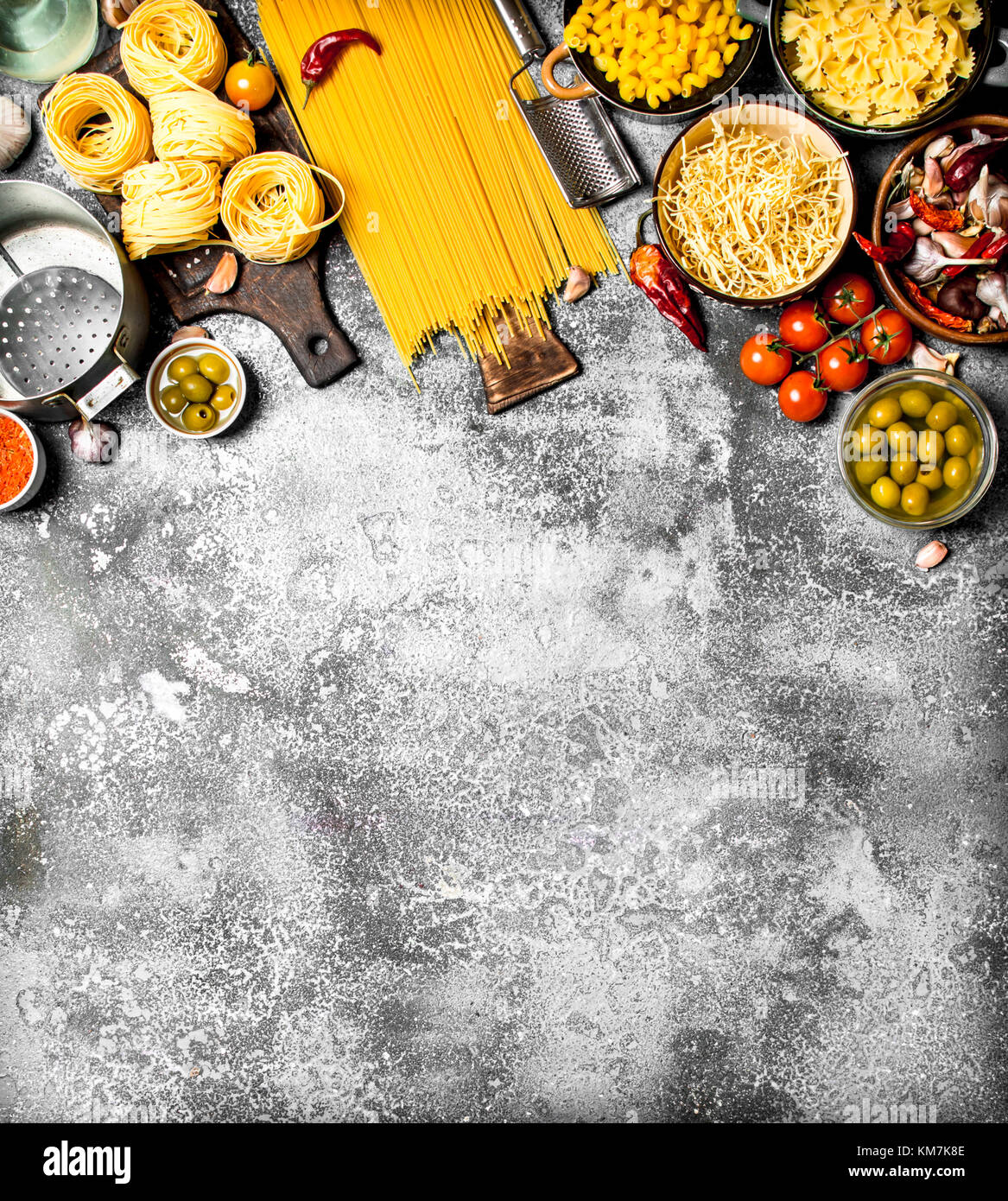 Pasta background. Various pasta with vegetables and spices.On rustic ...