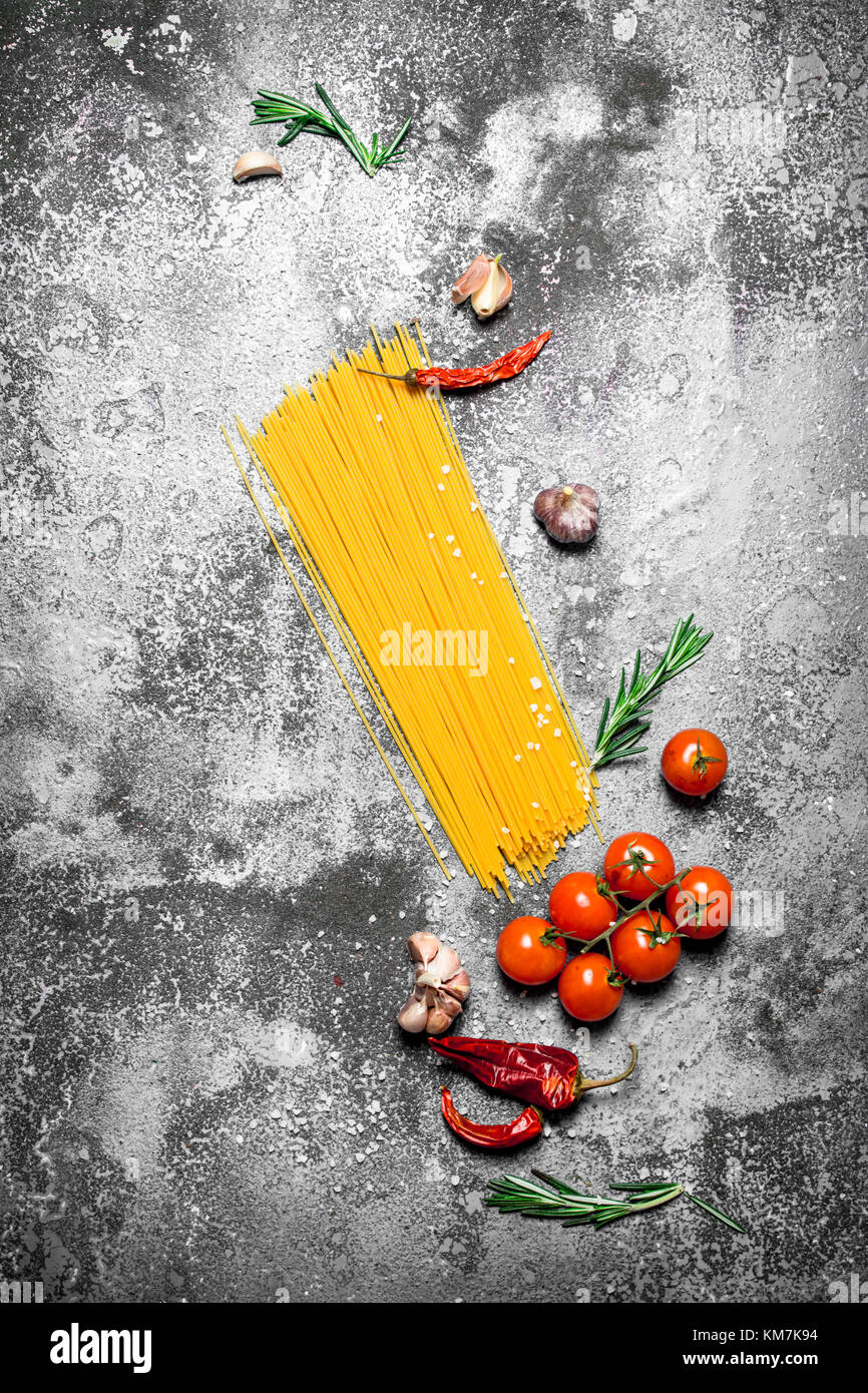 Pasta background. Spaghetti with tomatoes, rosemary and garlic.On ...