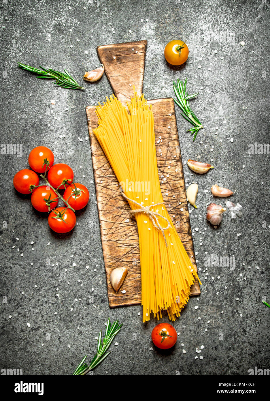 Pasta background. Spaghetti with garlic and tomatoes. On rustic ...