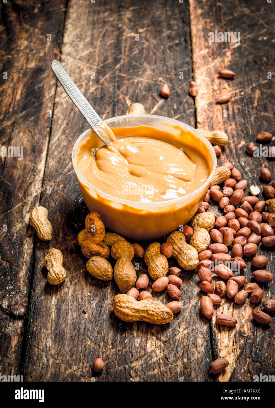 Peanut butter with nuts. On wooden background Stock Photo - Alamy
