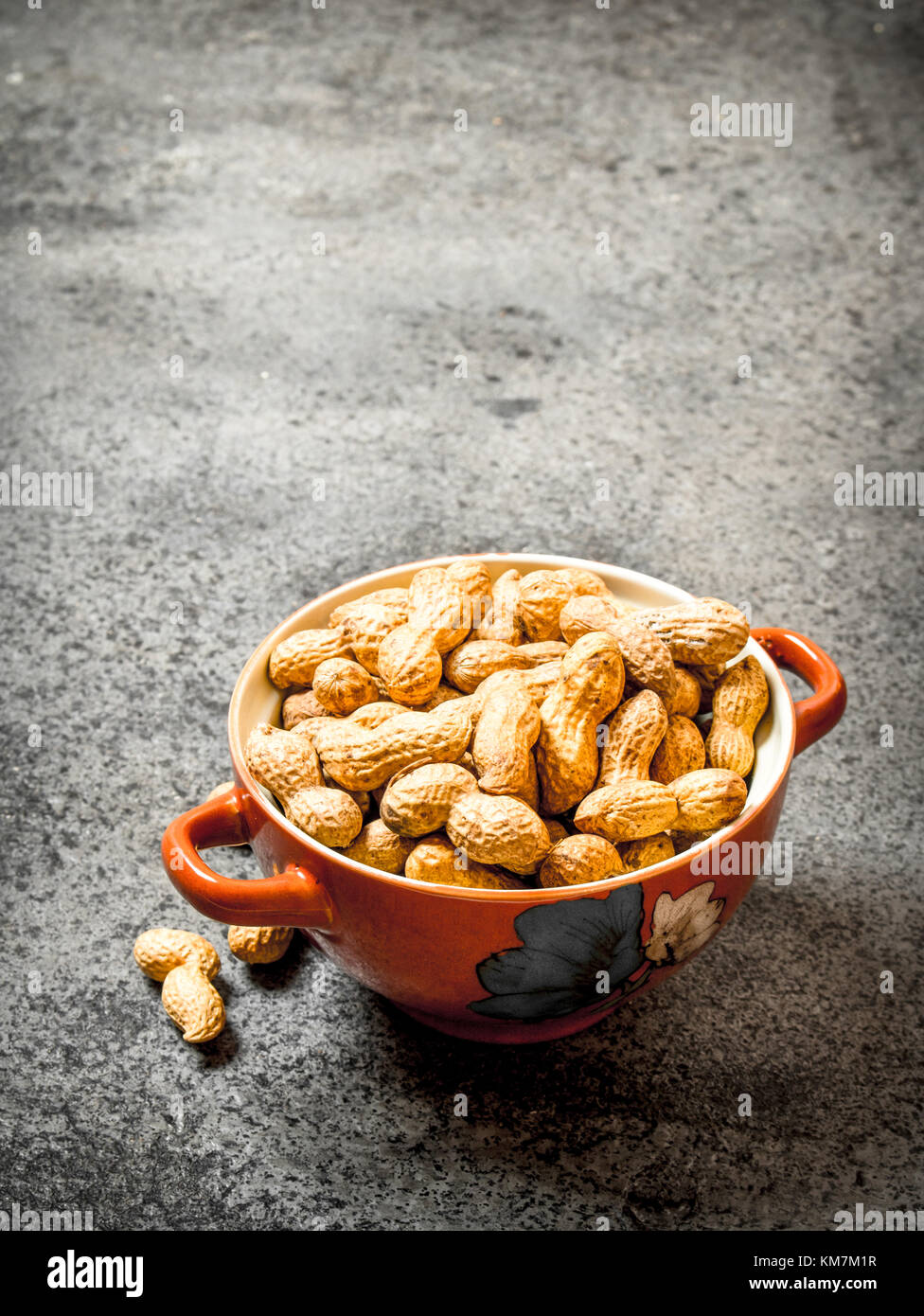 Peanuts in a bowl. On rustic background Stock Photo - Alamy