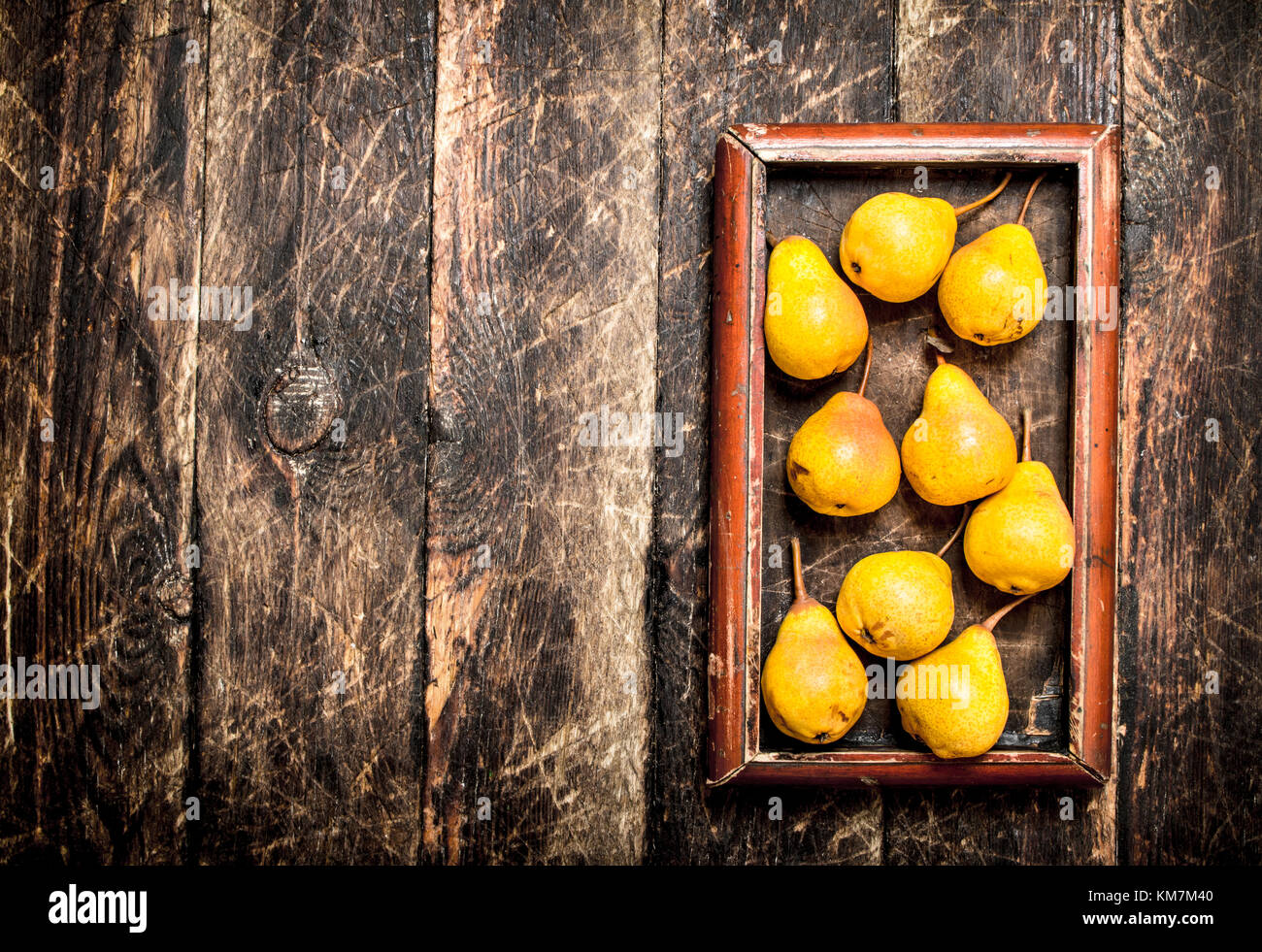 Fresh pears in the old tray. On wooden background Stock Photo - Alamy