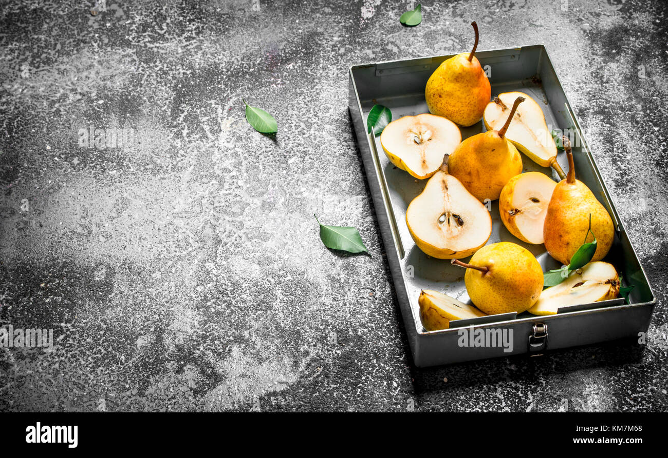 Pear pieces in a box. On rustic background Stock Photo - Alamy
