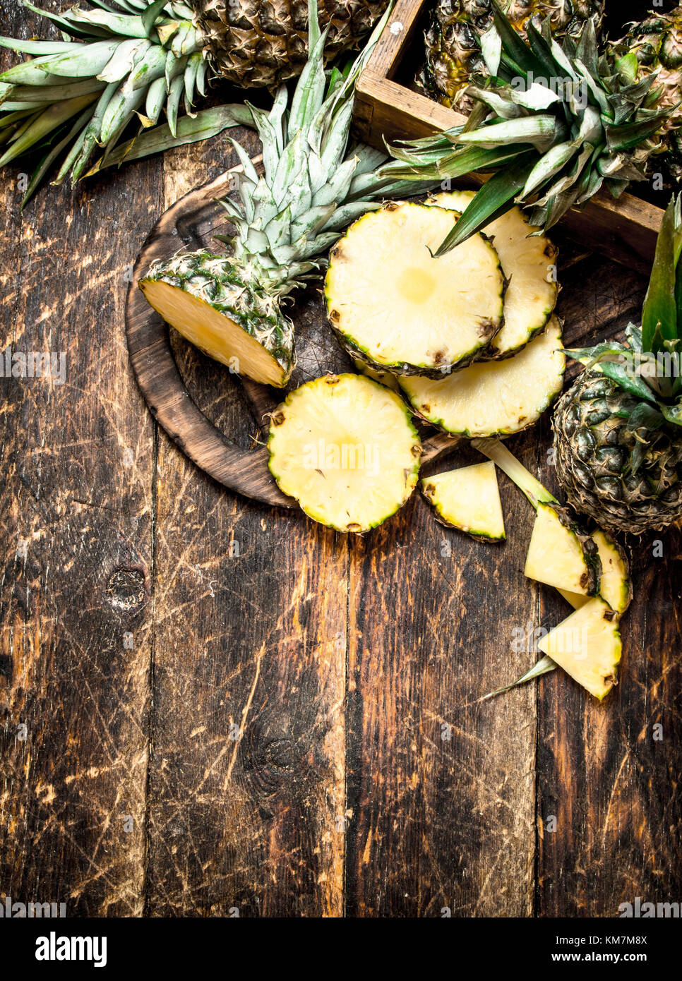 Sliced fresh pineapple. On the wooden background Stock Photo - Alamy
