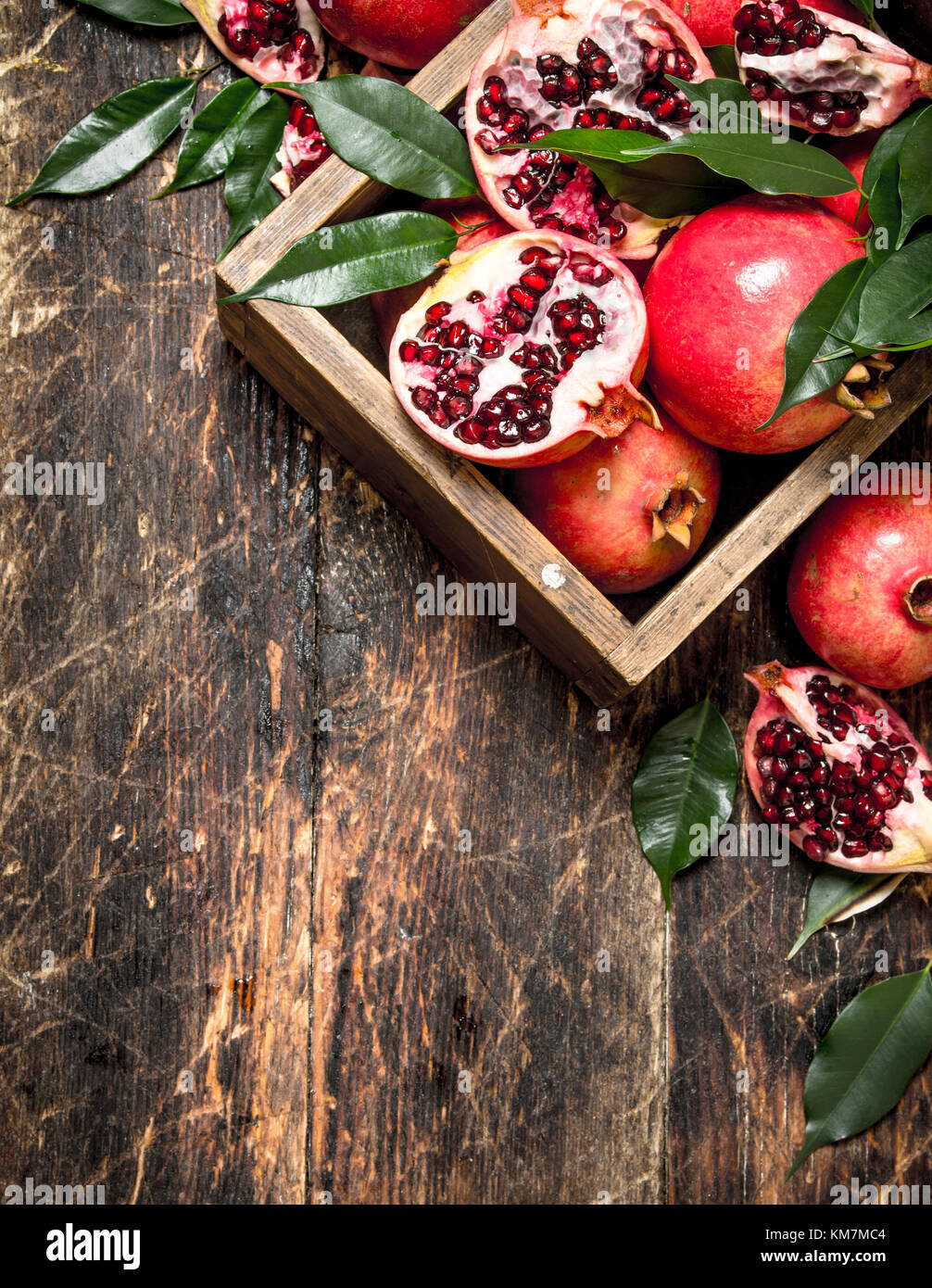 Fresh pomegranates in an old box. On wooden background Stock Photo - Alamy