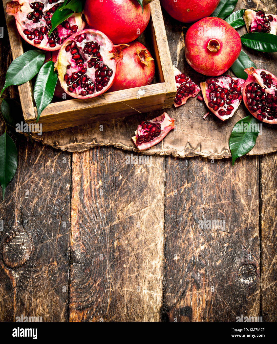 Fresh pomegranates in an old box. On wooden background Stock Photo - Alamy