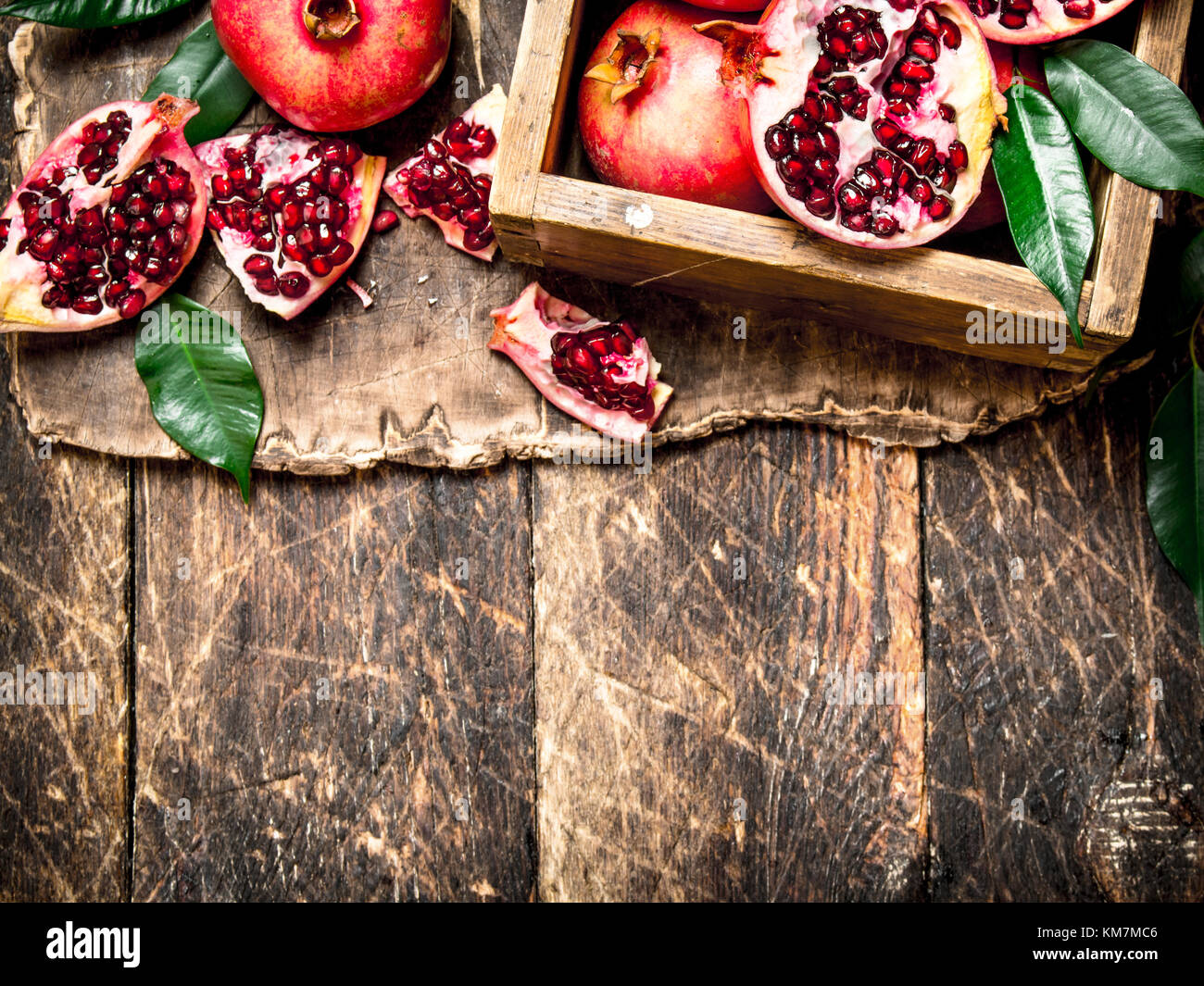 Fresh pomegranates in an old box. On wooden background Stock Photo - Alamy