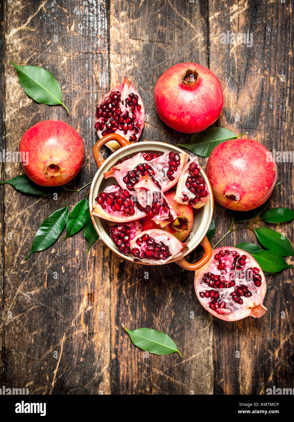 Fresh pomegranates in a bowl. On wooden background Stock Photo - Alamy