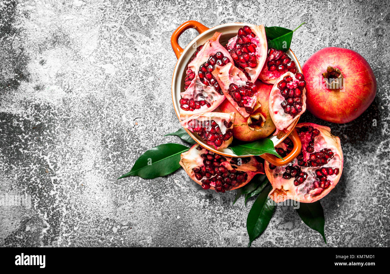 Pieces of fresh pomegranate in a bowl. On rustic background Stock Photo ...