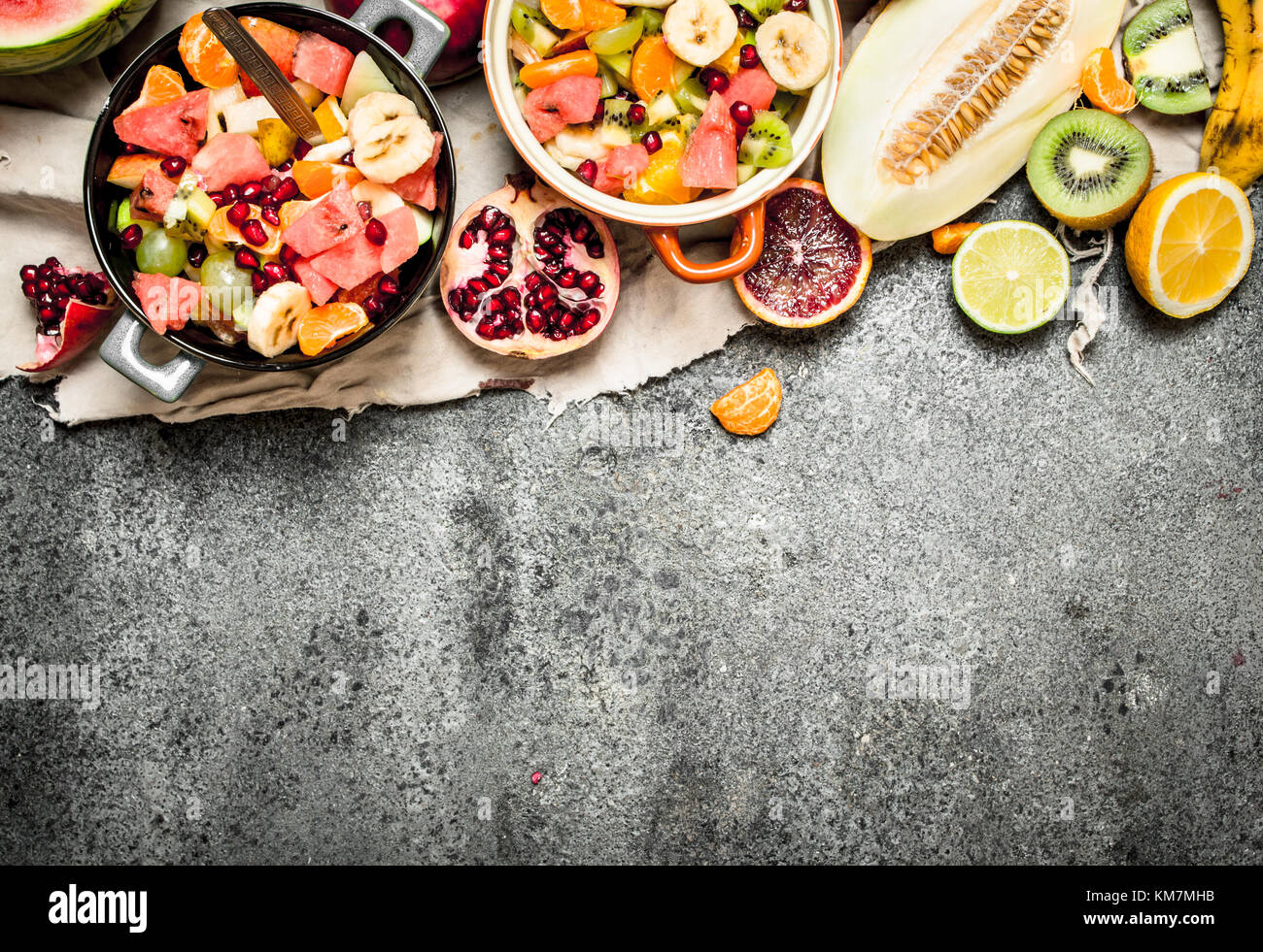 Tropical food . Fresh tropical fruit salad in bowls. On rustic ...
