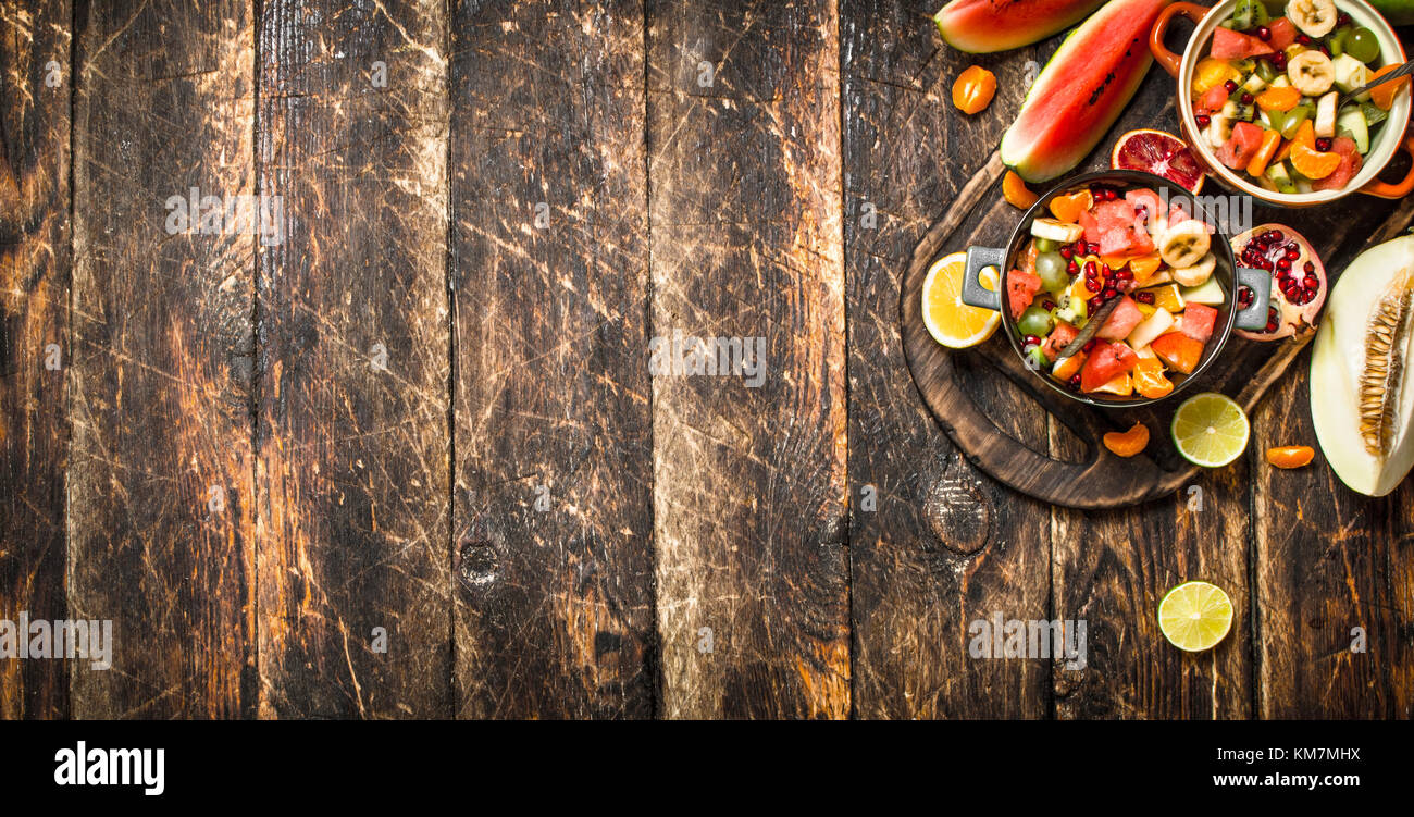 Summer food . Salad of tropical fruits. On wooden background Stock ...