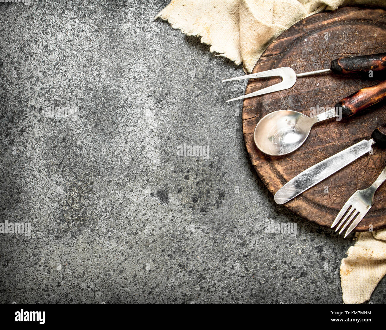 Serving background. Cutlery on the old Board. On rustic background ...