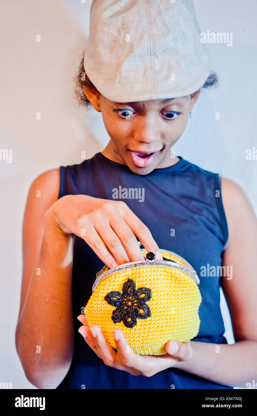 young girl with clear hat smiles joyfully when she looks in her small ...