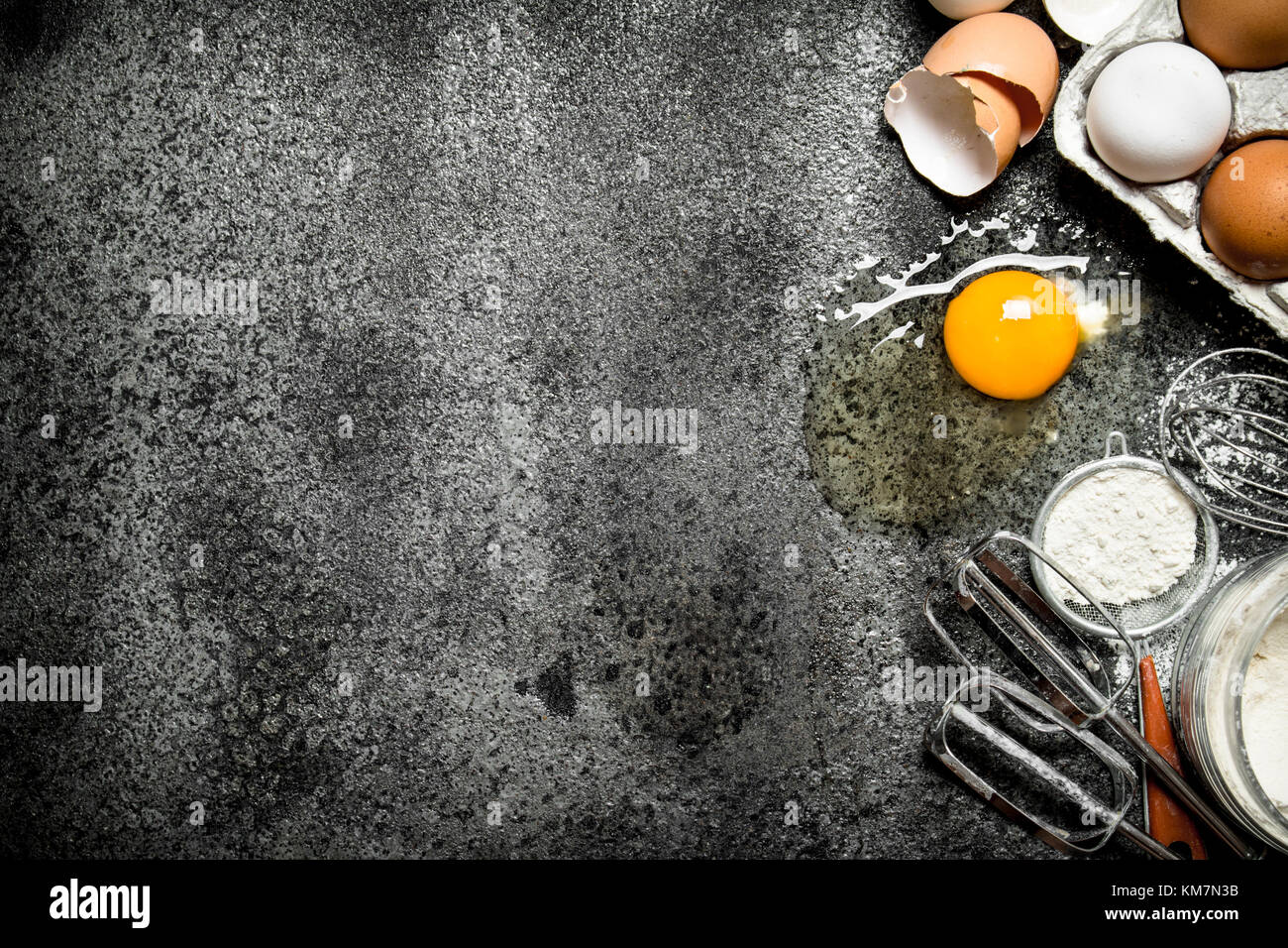 Baking background.Fresh eggs from the scattered flour. On rustic ...
