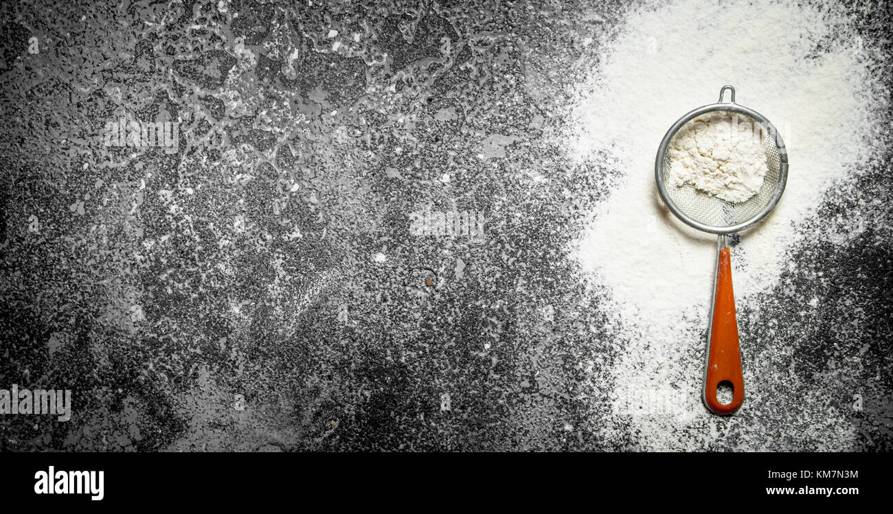 Baking background. Sieve sifted flour. On rustic background Stock Photo ...