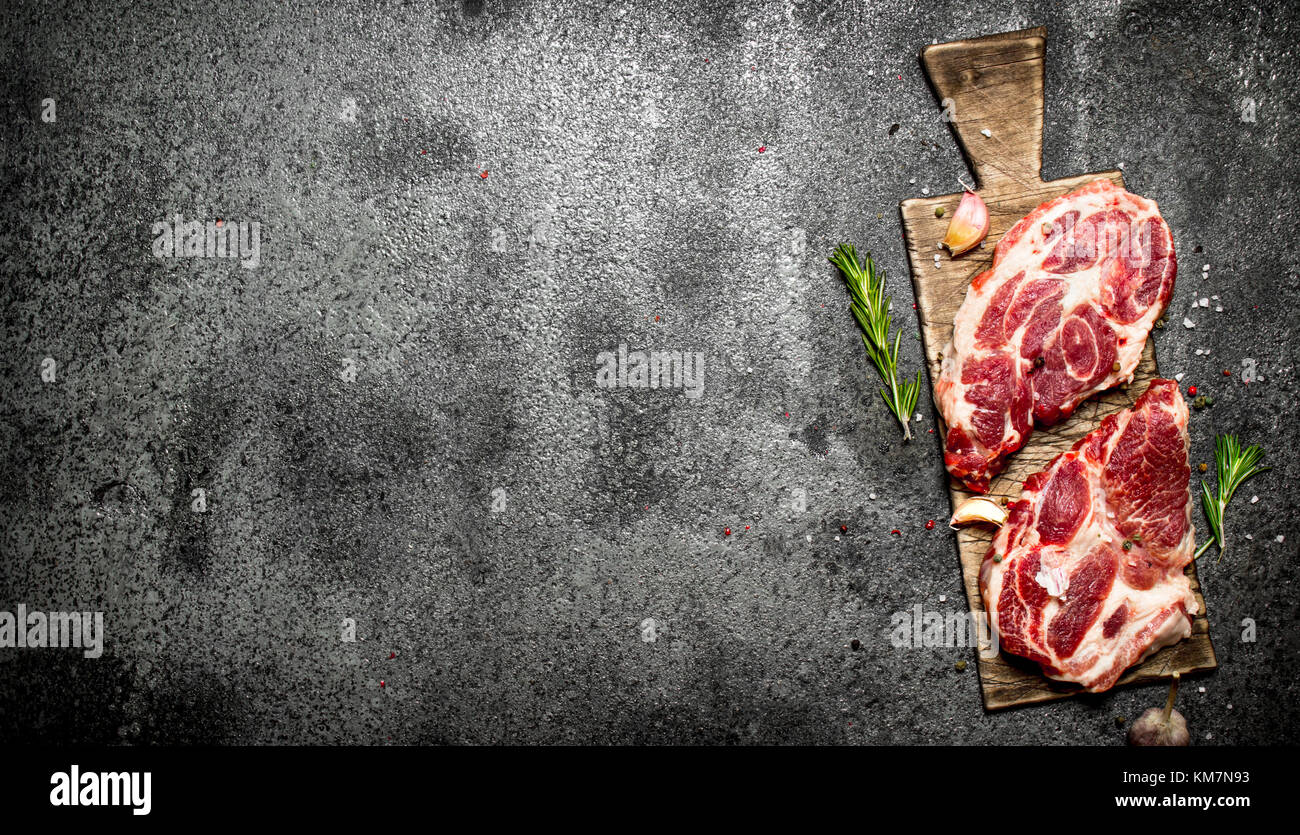Raw meat background. A piece of Raw pork chops with fragrant spices and ...
