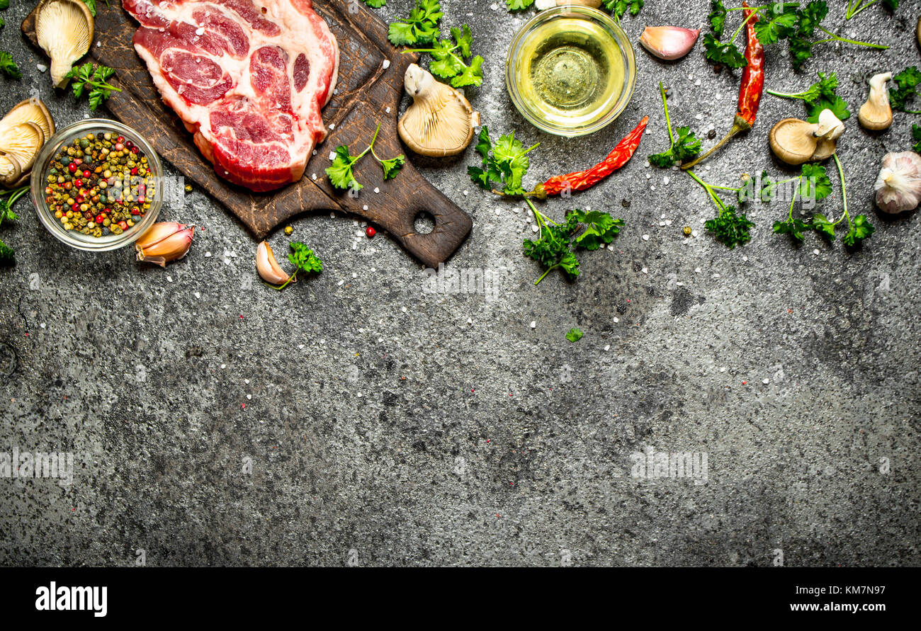 Raw meat background. A piece of Raw pork chops with fragrant spices and ...