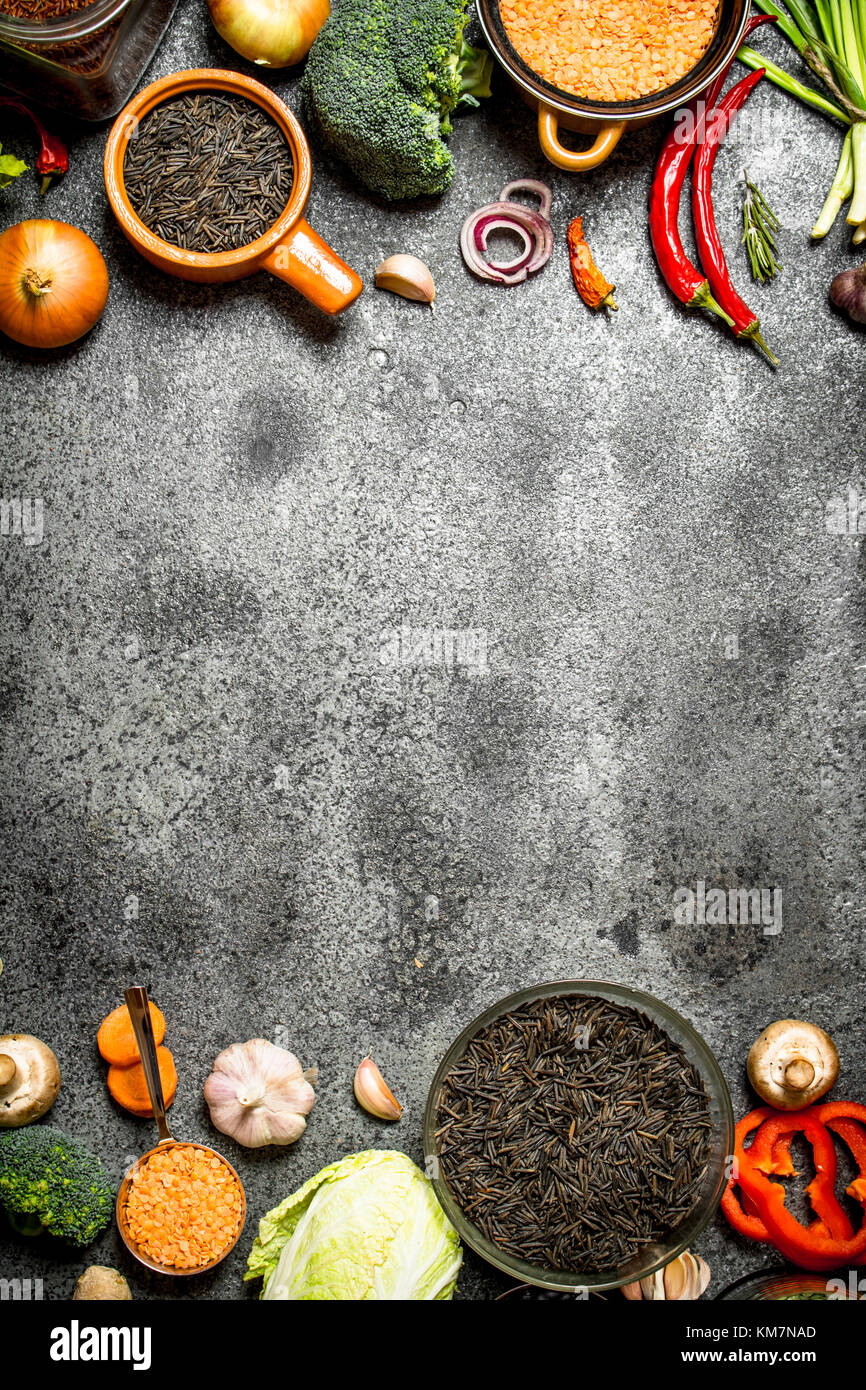 Organic Food. A variety of legumes with vegetables. On rustic ...